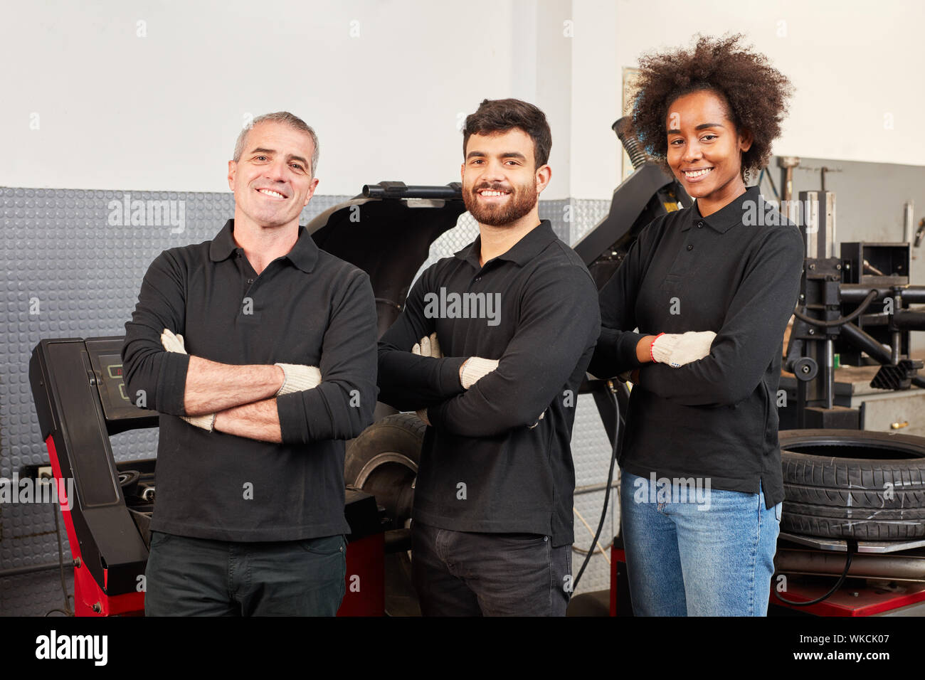 Multicultural mechanic and mechatronics team together in auto repair ...