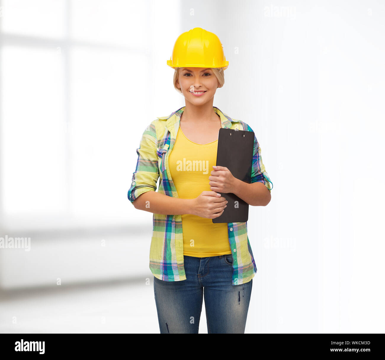 repair, construction and maintenance concept - smiling woman in helmet ...