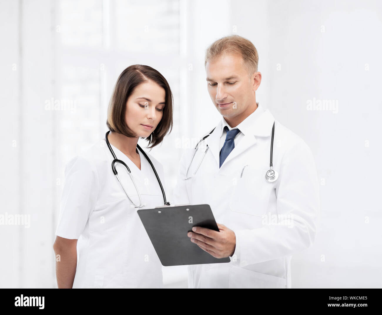 healthcare and medical concept - two doctors writing prescription Stock ...