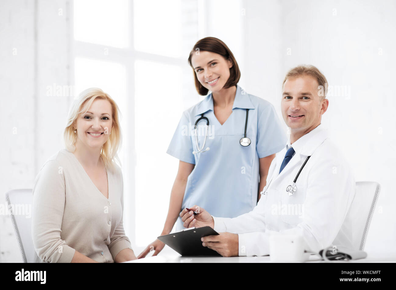 healthcare and medical concept - doctor and nurse with patient in ...