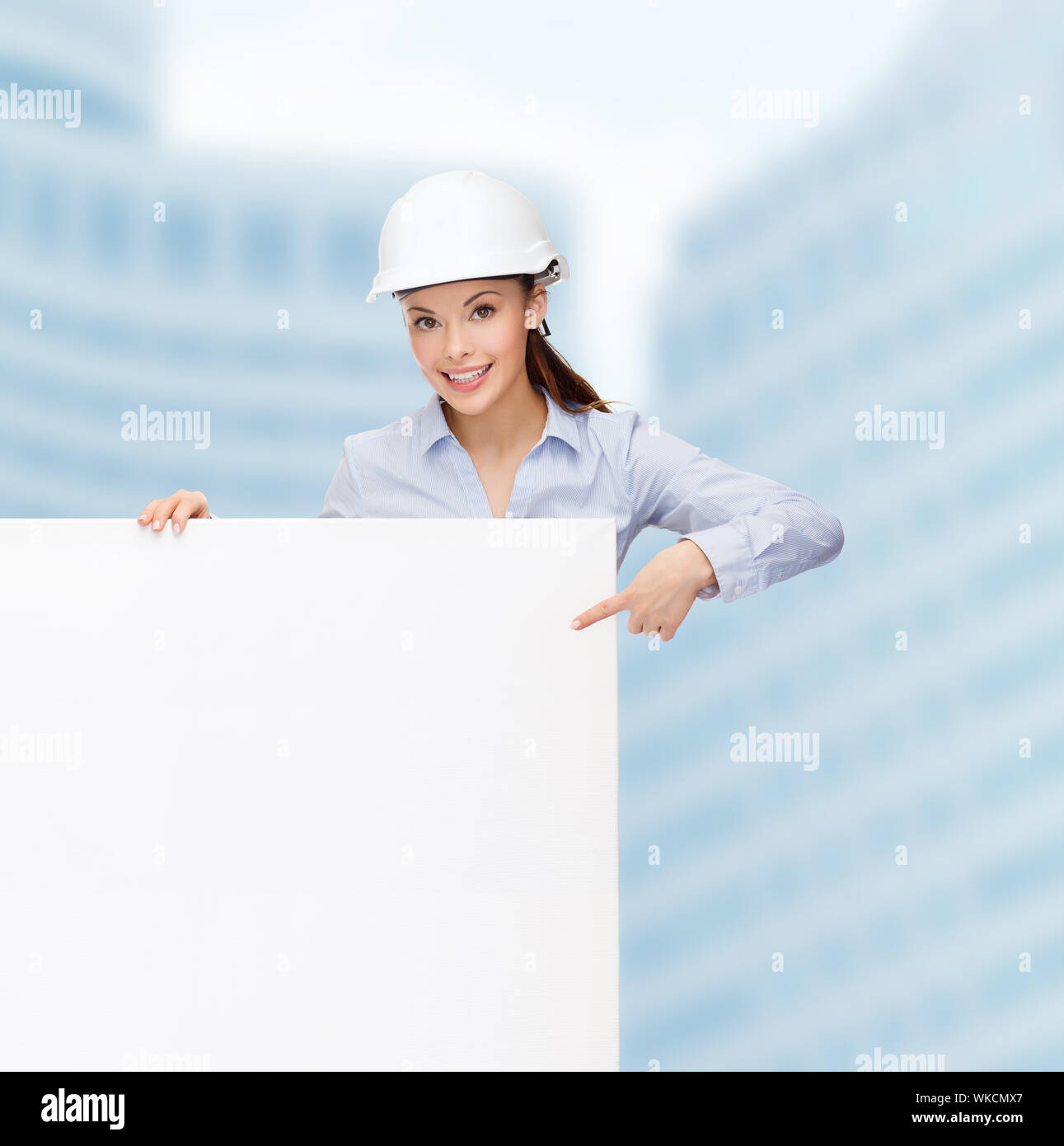 businesswoman in helmet pointing finger to board Stock Photo - Alamy