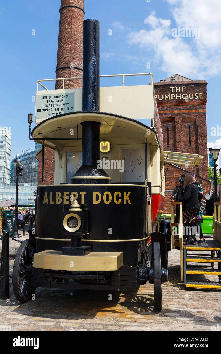 A classic steam bus against a classic building at the Liverpool Docks ...