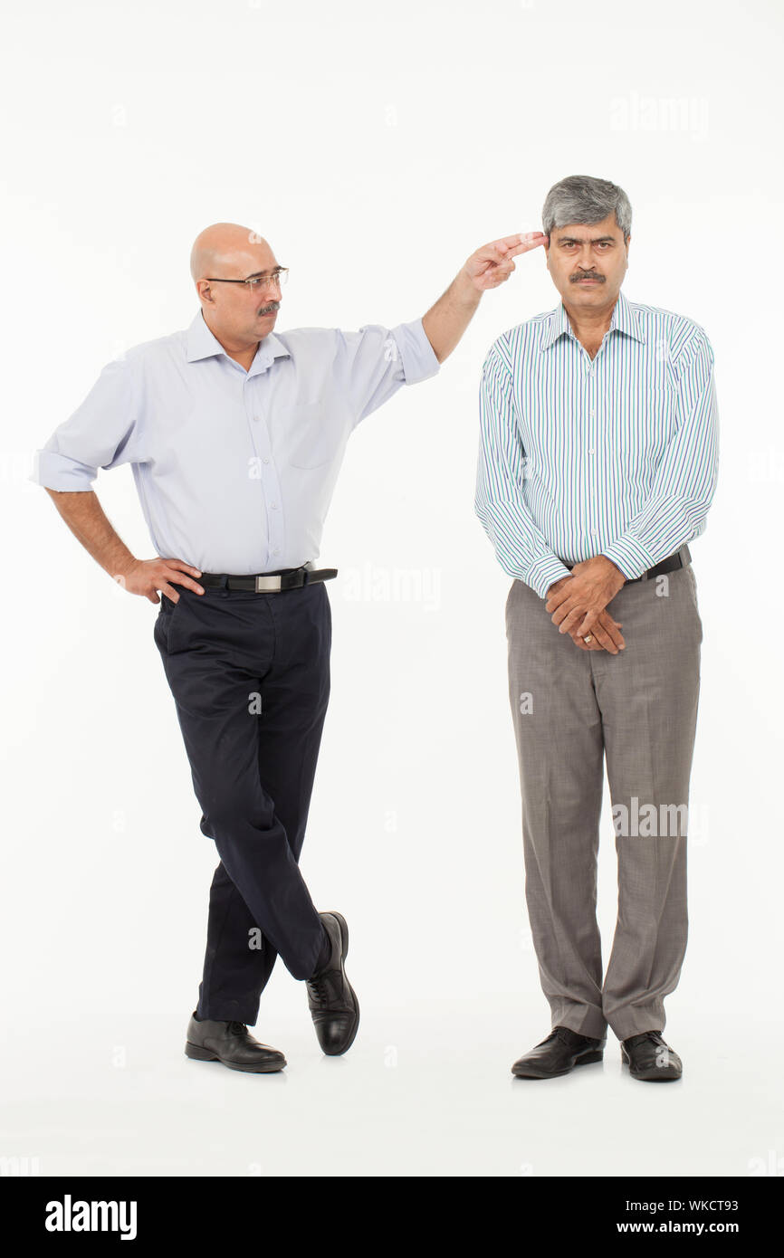 Businessman pointing finger gun to his employee Stock Photo - Alamy