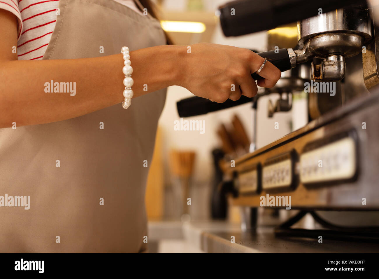 Barista feeling busy. Female barista wearing bracelet feeling busy ...