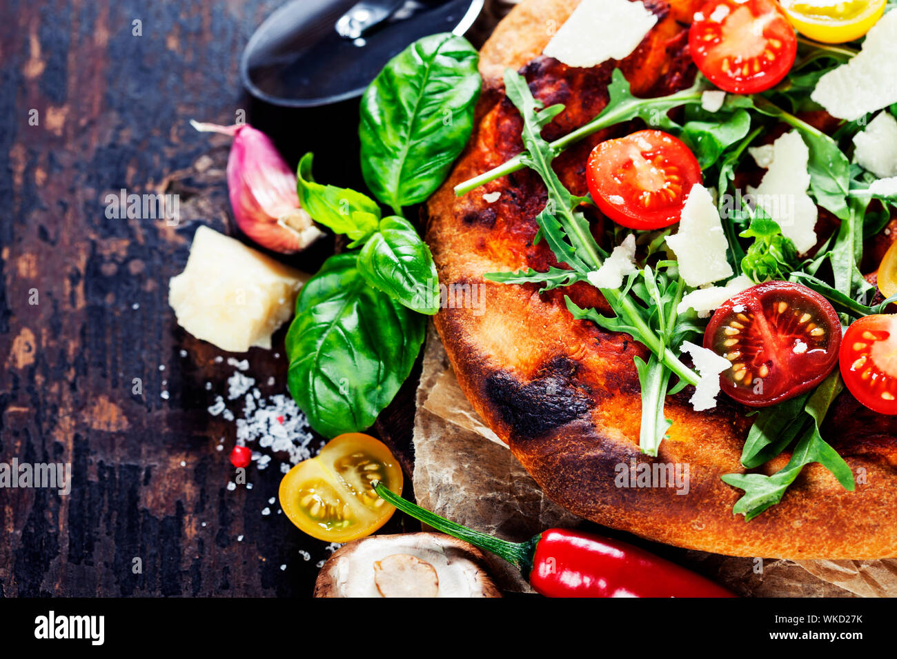 pizza and fresh italian ingredients on a dark background Stock Photo ...