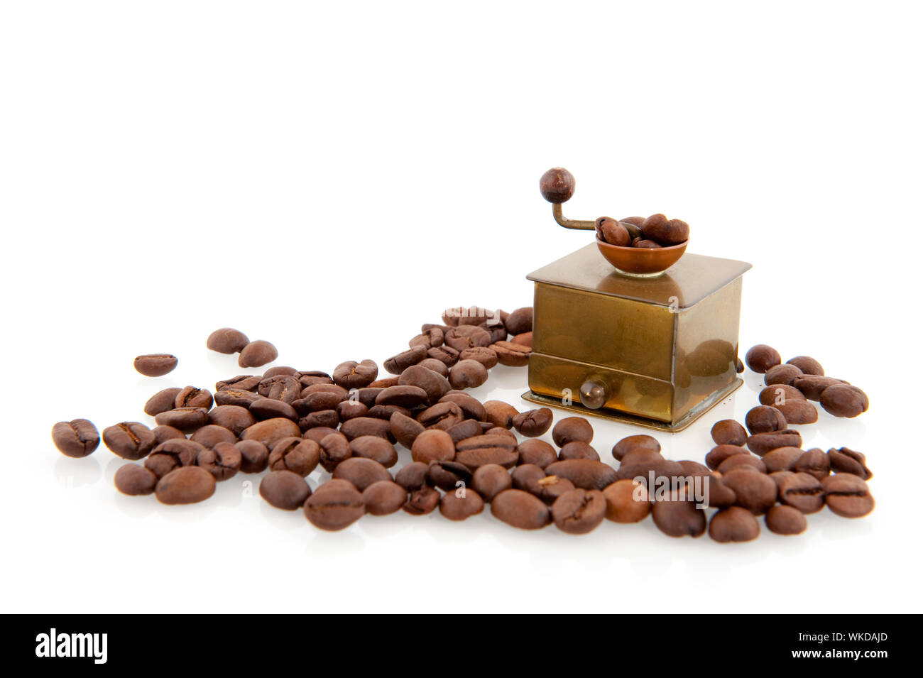 crushing the coffee beans with a copper mill Stock Photo - Alamy