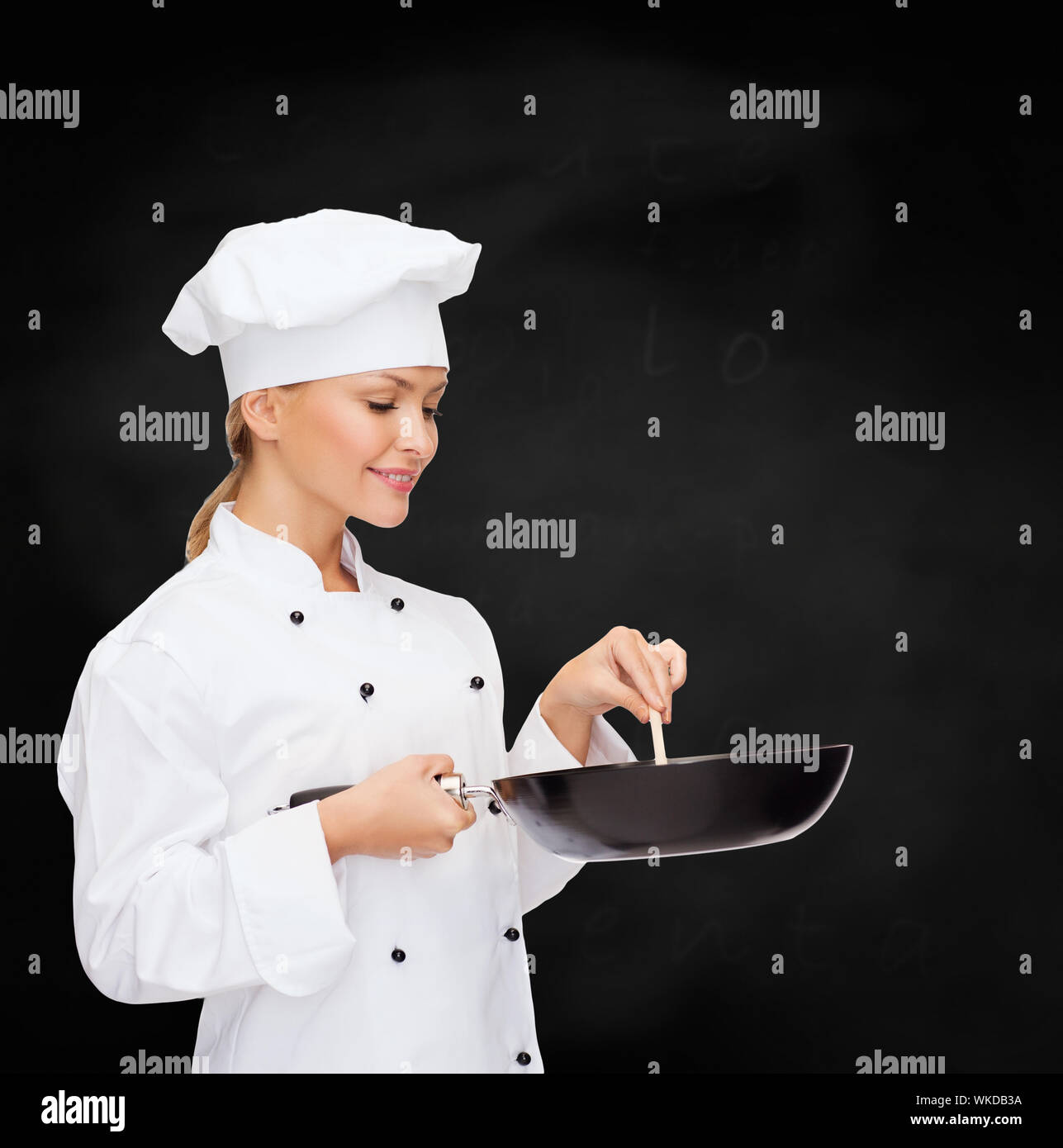 smiling female chef with pan and spoon Stock Photo - Alamy