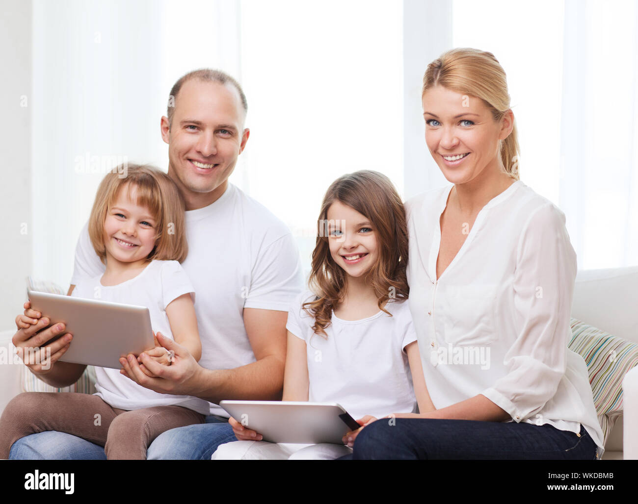 family, children, technology, money and home concept - smiling family ...