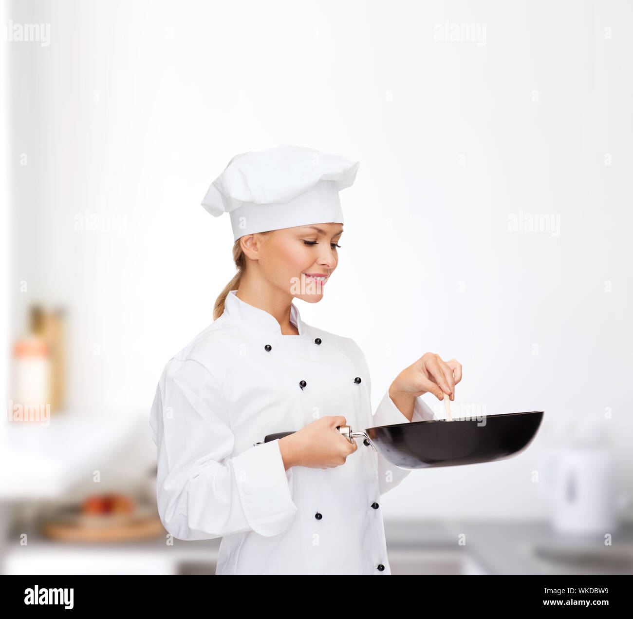 smiling female chef with pan and spoon Stock Photo - Alamy