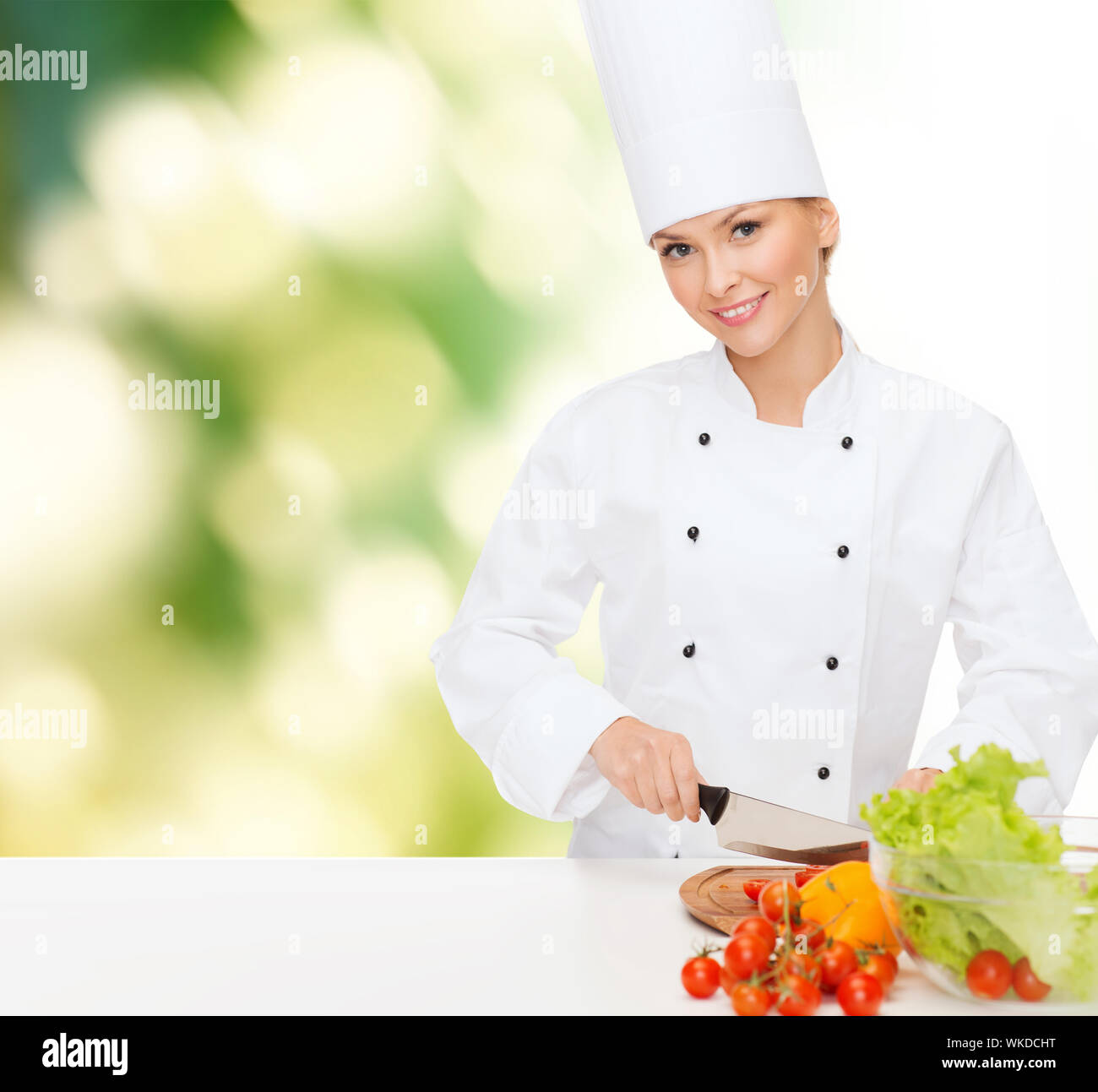 smiling female chef chopping vagetables Stock Photo - Alamy