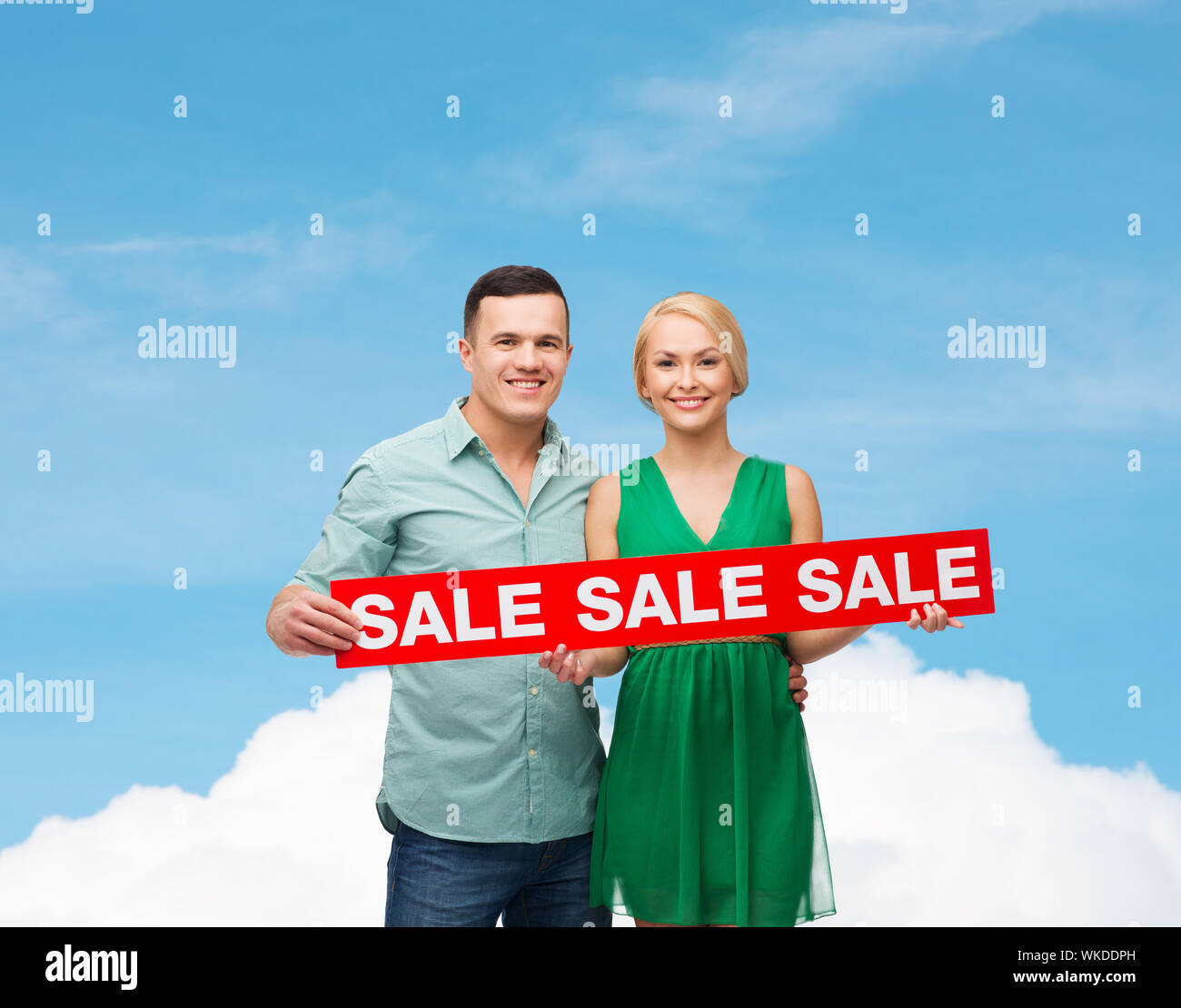 smiling couple with sale sign Stock Photo - Alamy