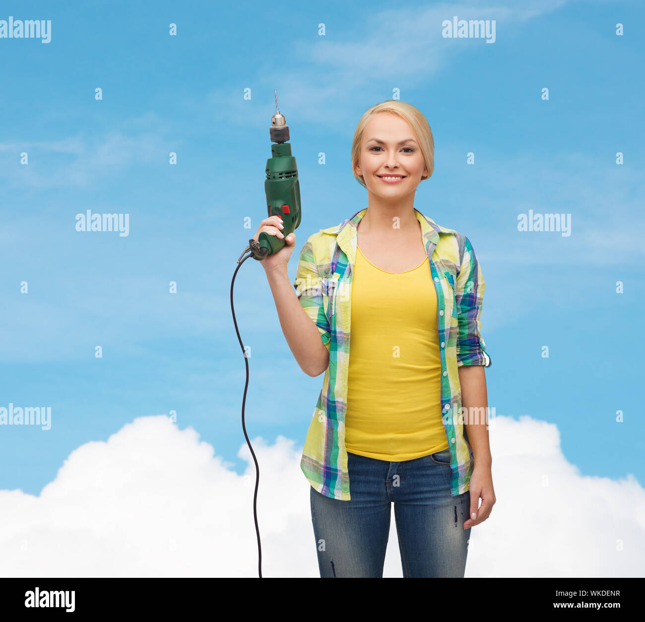 repair, construction and maintenance concept - smiling woman with drill ...