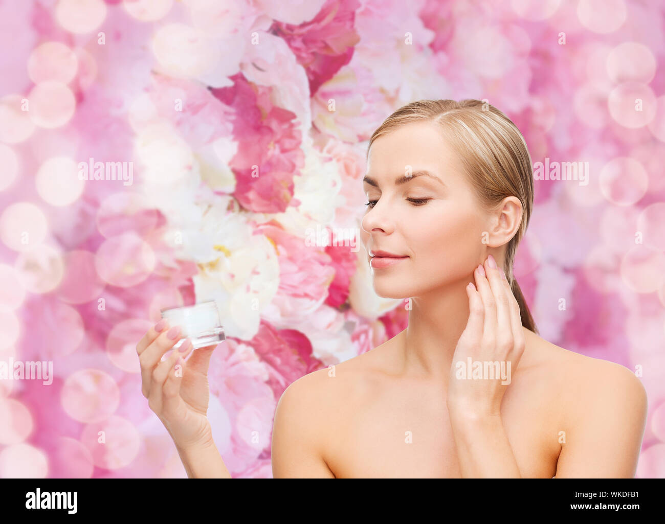 woman applying cream on her skin Stock Photo - Alamy