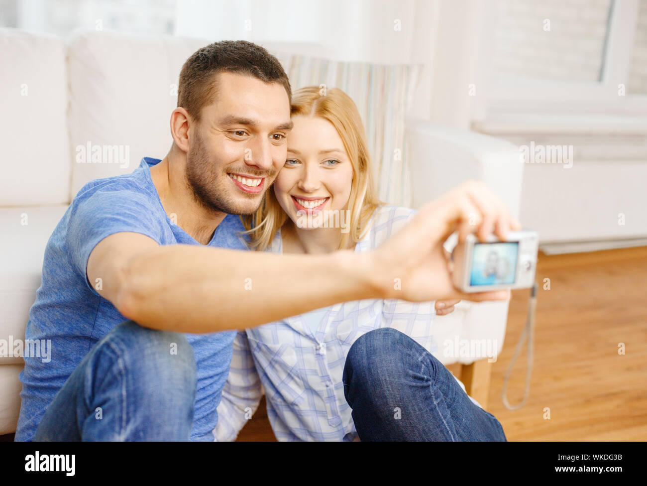 love, family, technology and happiness concept - smiling couple taking ...