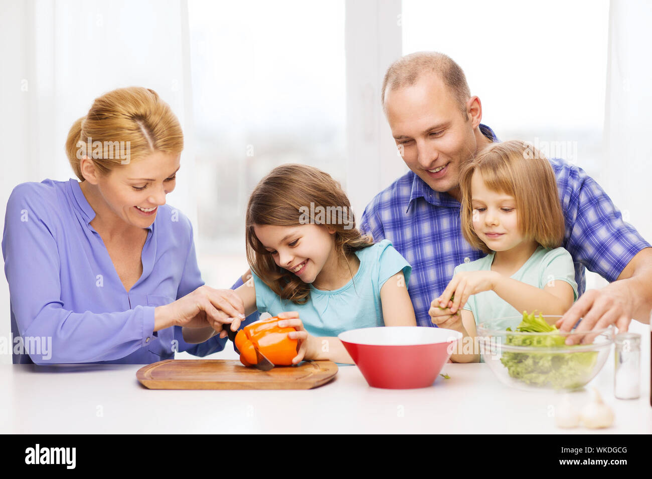 happy family with two kids making dinner at home Stock Photo - Alamy