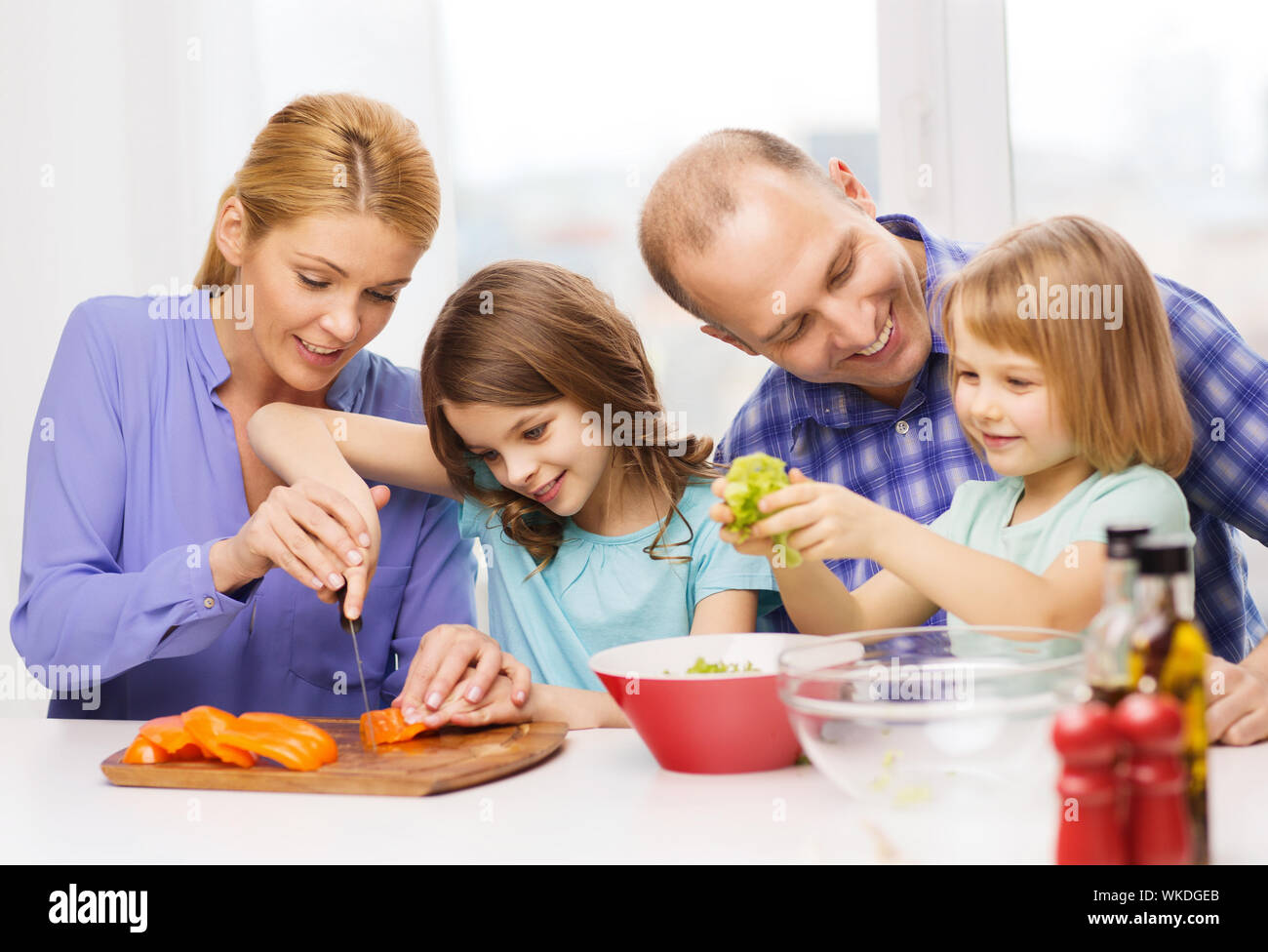 happy family with two kids making dinner at home Stock Photo - Alamy