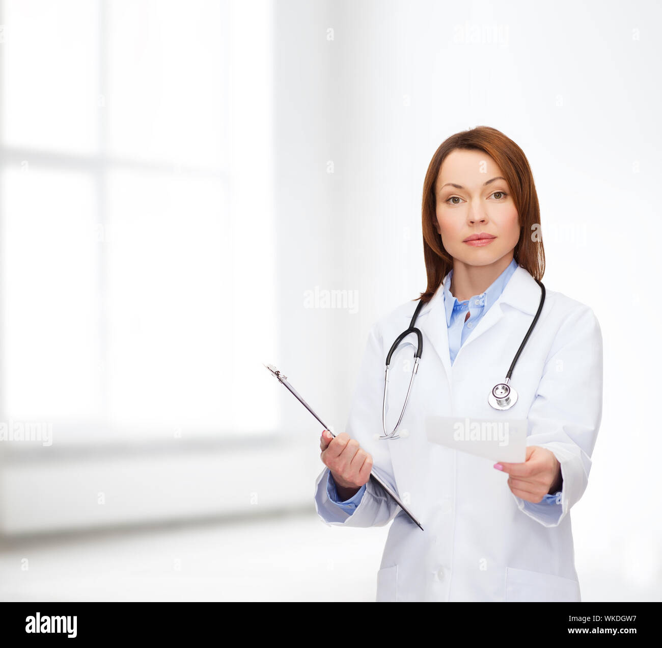 calm female doctor with clipboard Stock Photo - Alamy