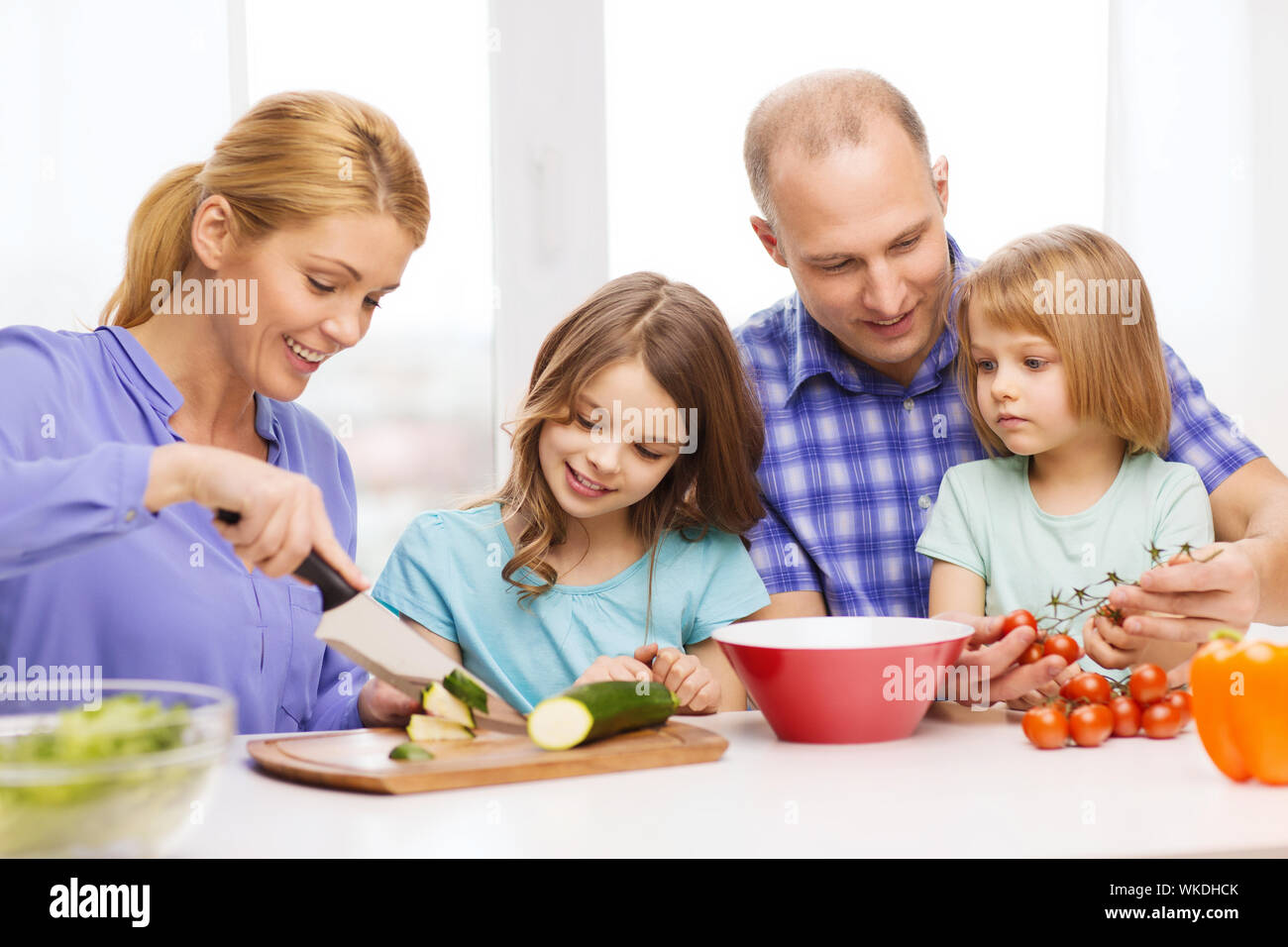 happy family with two kids making dinner at home Stock Photo - Alamy