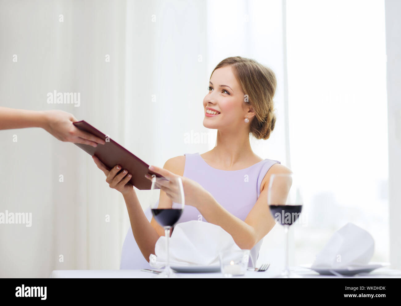 reastaurant and happiness concept - smiling young woman giving menu to ...