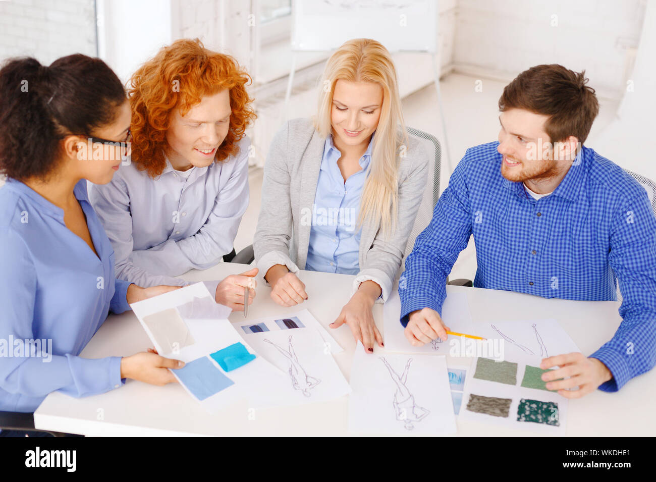 Smiling creative team looking sketch hi-res stock photography and ...