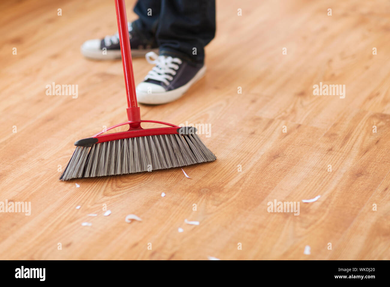 close up of male brooming wooden floor Stock Photo - Alamy