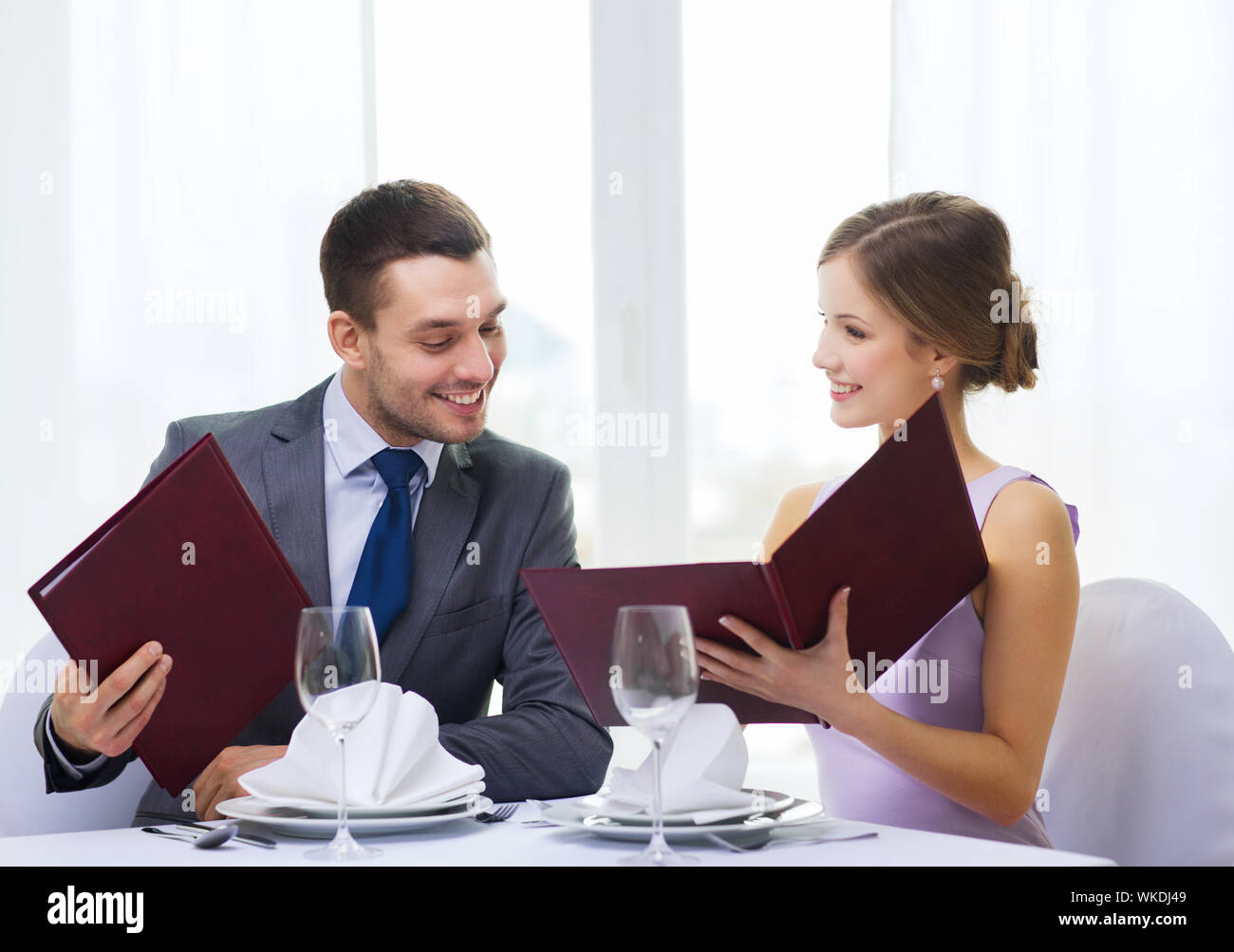 Two girlfriends talking reading menu hi-res stock photography and ...