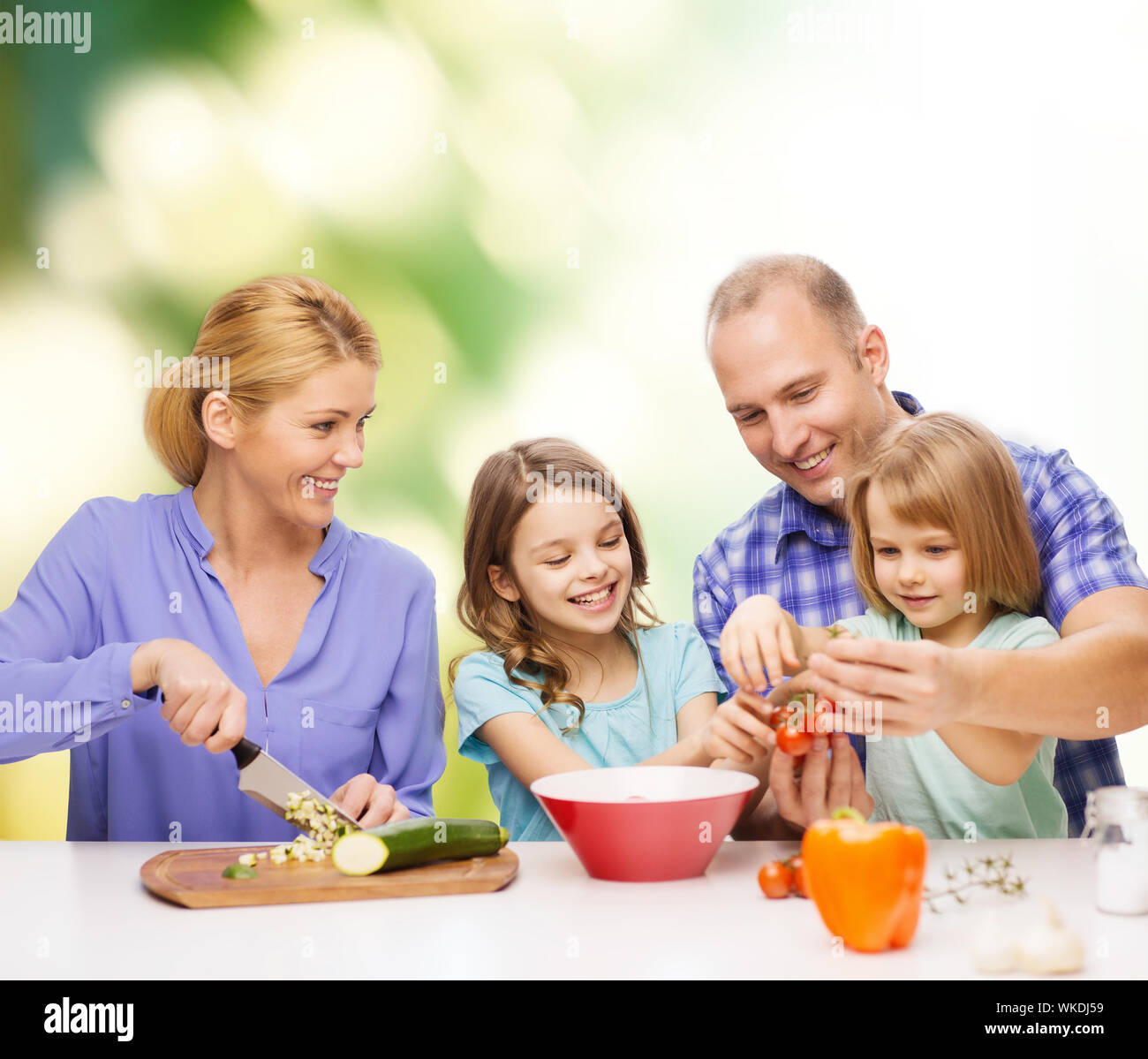 happy family with two kids making dinner at home Stock Photo - Alamy