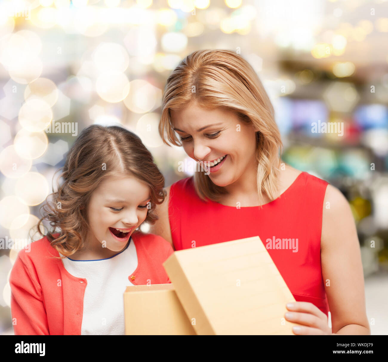 smiling mother and daughter opening gift box Stock Photo - Alamy