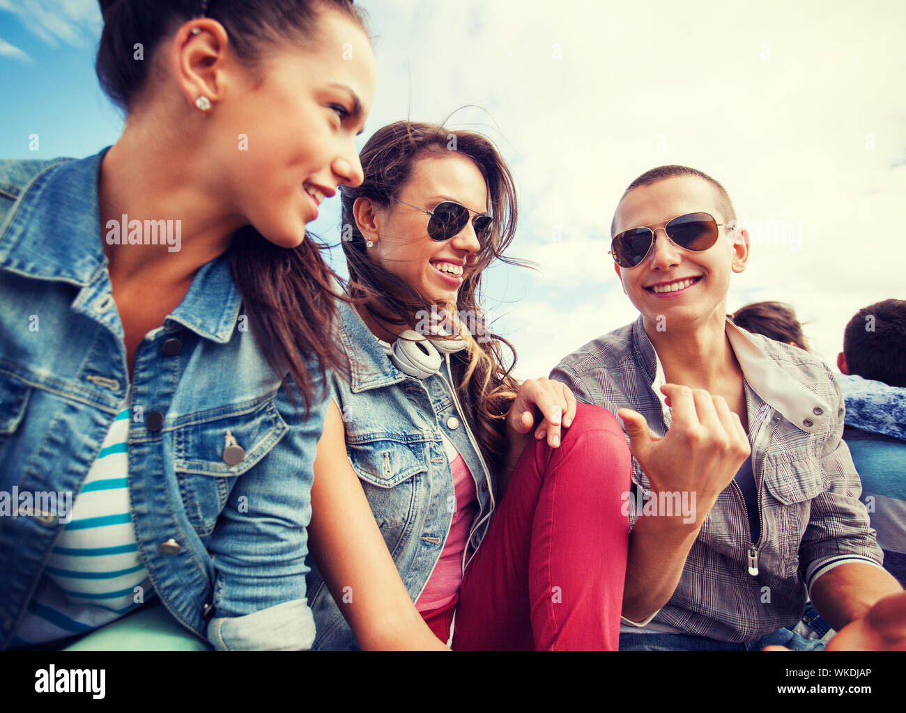 summer holidays and teenage concept - group of teenagers hanging out ...