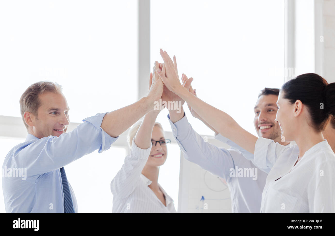 happy business team giving high five in office Stock Photo - Alamy