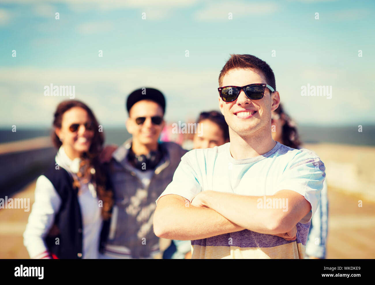 teenager in shades outside with friends Stock Photo - Alamy