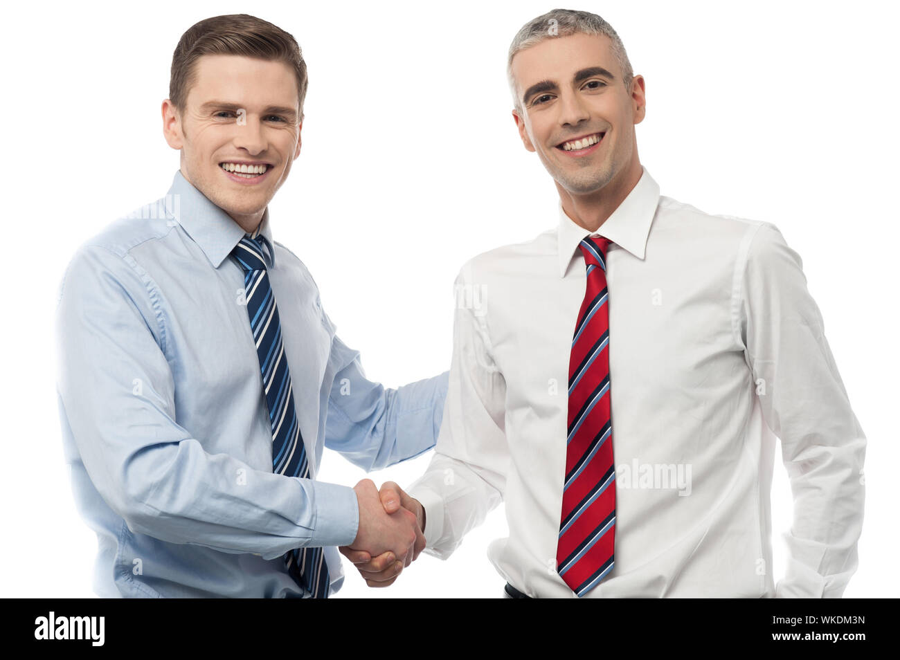 Smiling business people shaking hands over a deal Stock Photo - Alamy