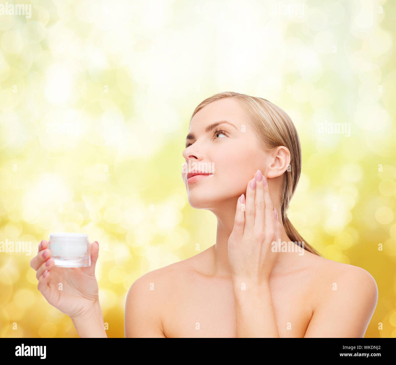 woman applying cream on her skin Stock Photo - Alamy