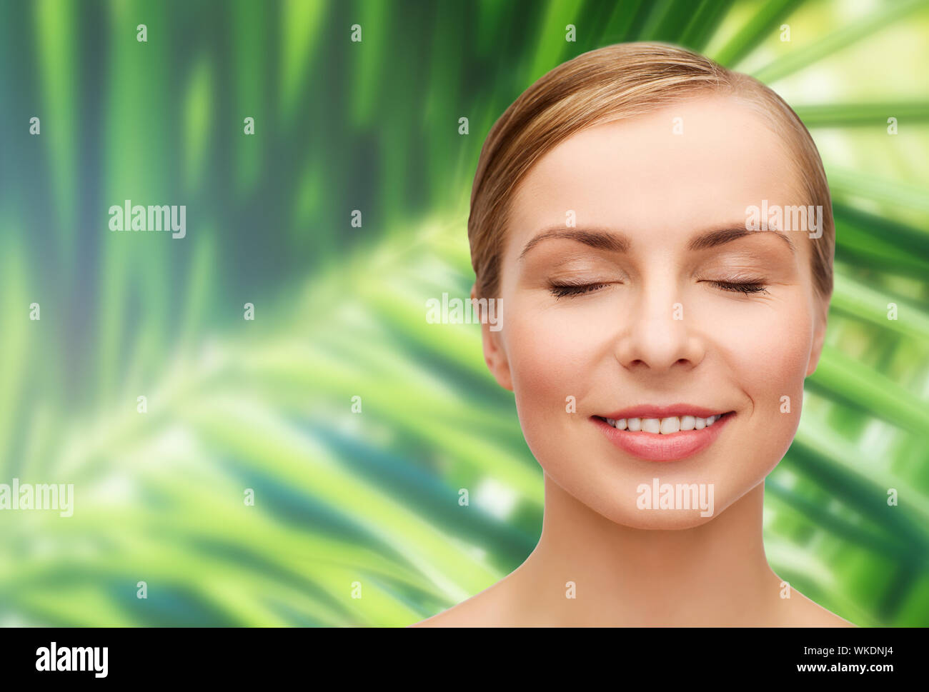 health and beauty concept - closeup of face of beautiful young woman ...