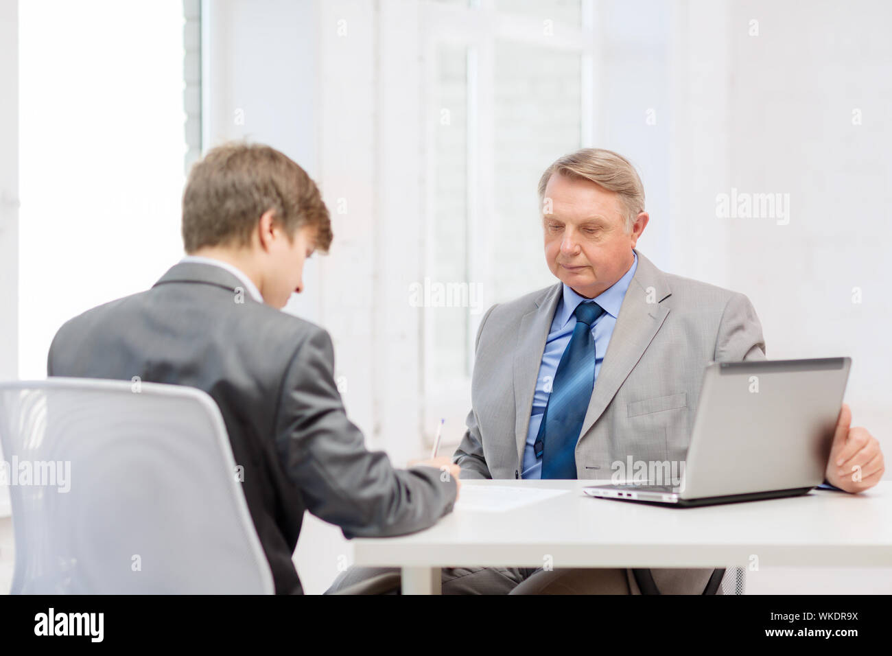 business, technology and office concept - older man and young man ...