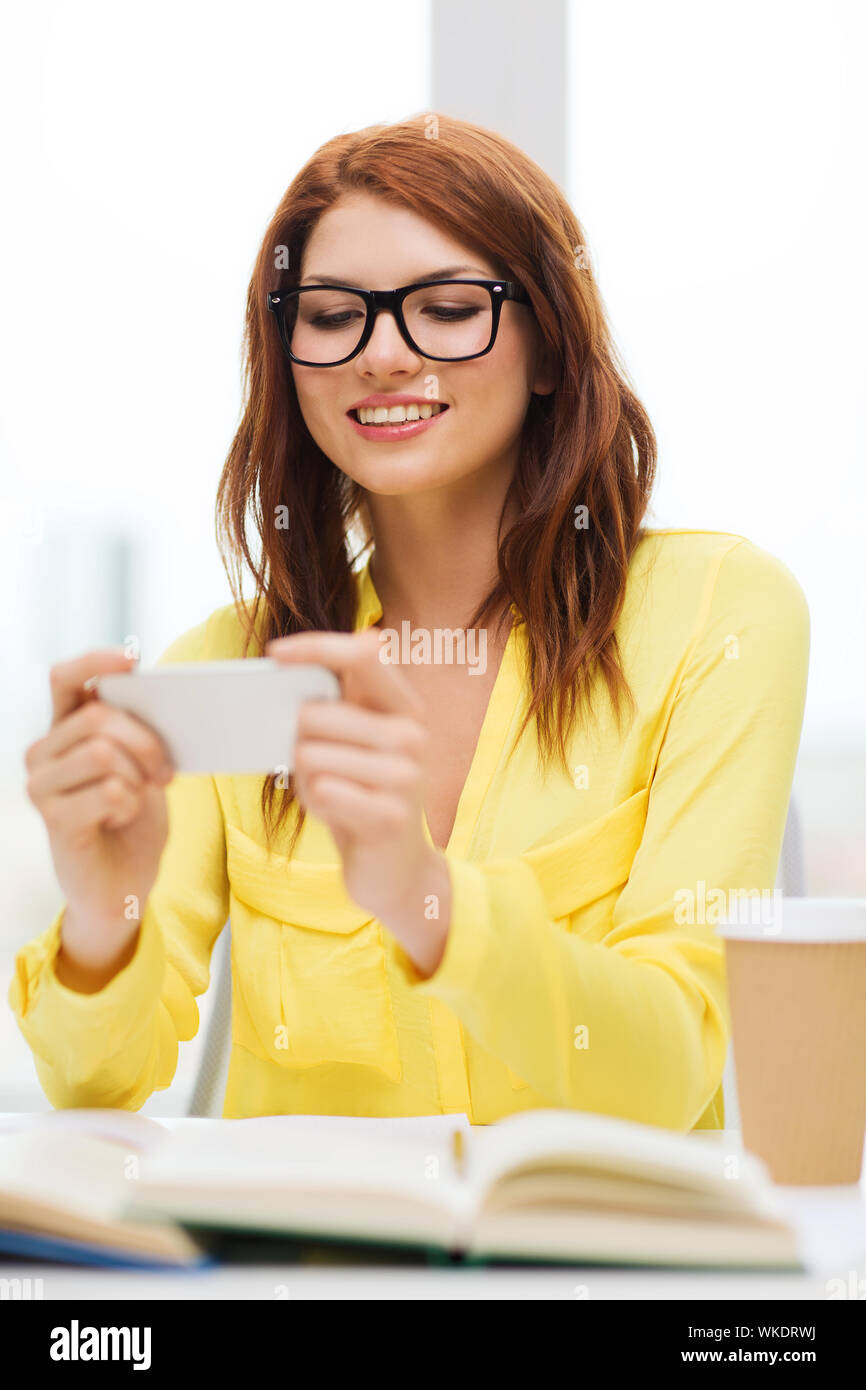 smiling student girl with smartphone at school Stock Photo - Alamy