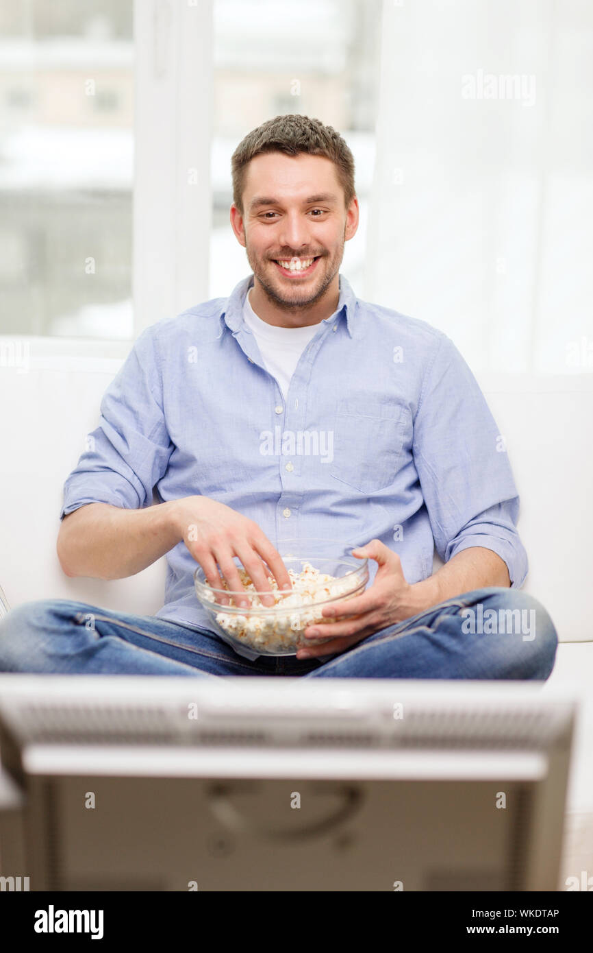 smiling man watching sports at home Stock Photo - Alamy