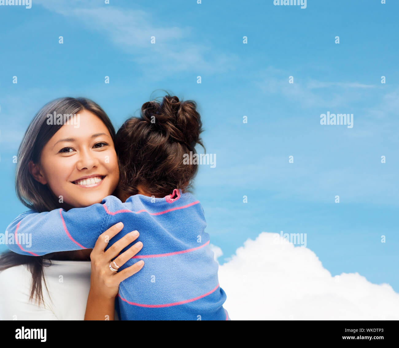 family, children and happy people concept - hugging mother and daughter ...