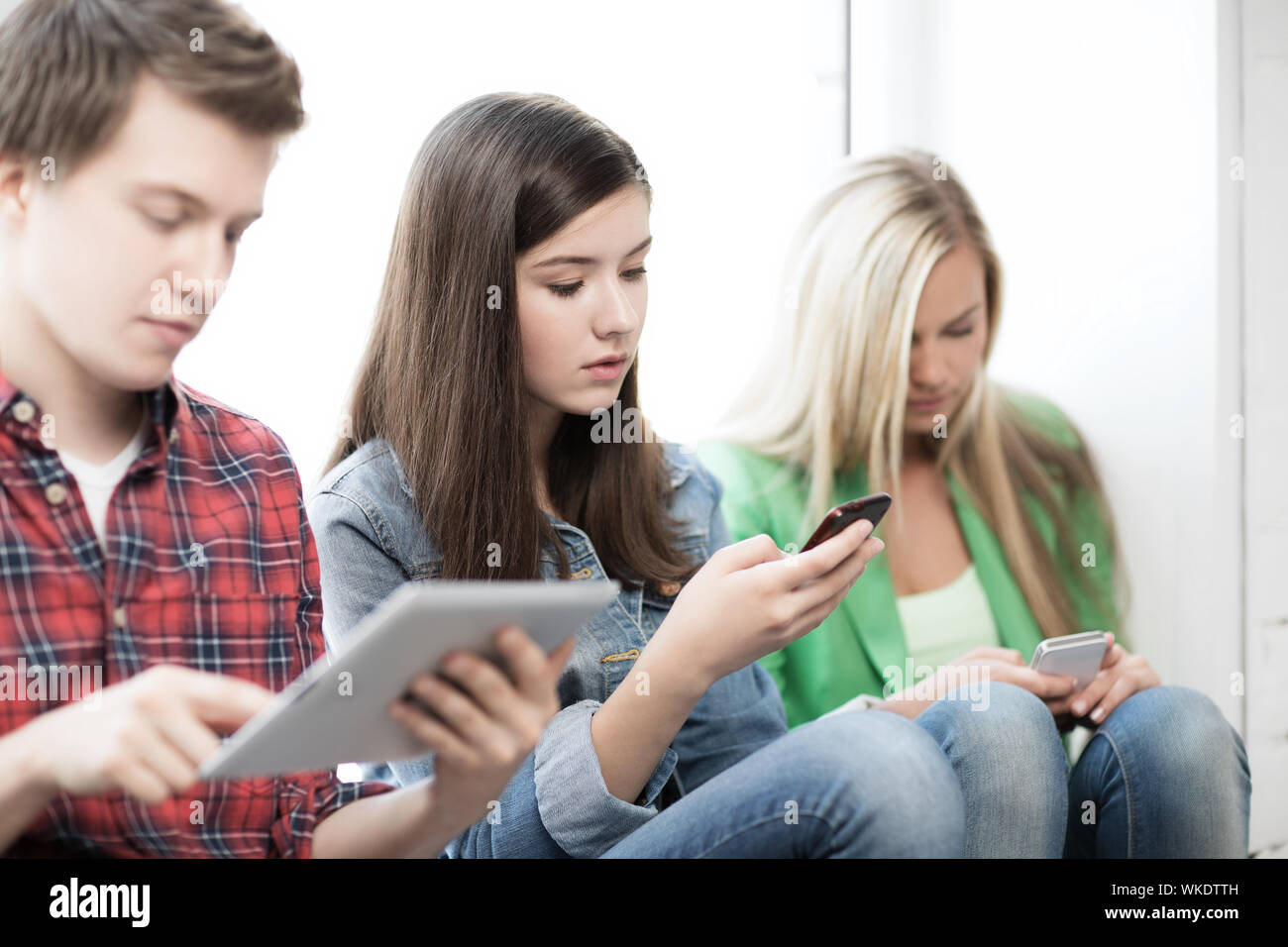 students looking into devices at school Stock Photo - Alamy