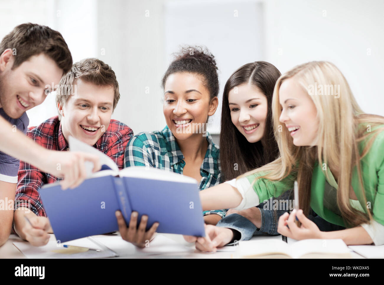 students reading book at school Stock Photo - Alamy