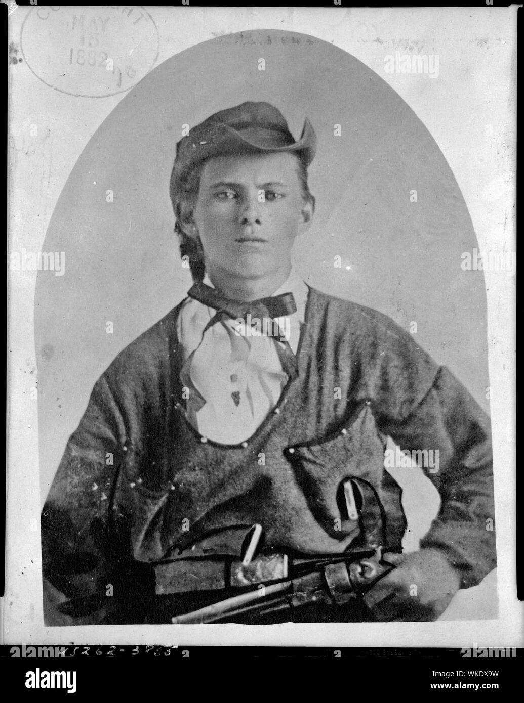 Jesse James, half-length portrait, facing front, holding handgun in ...