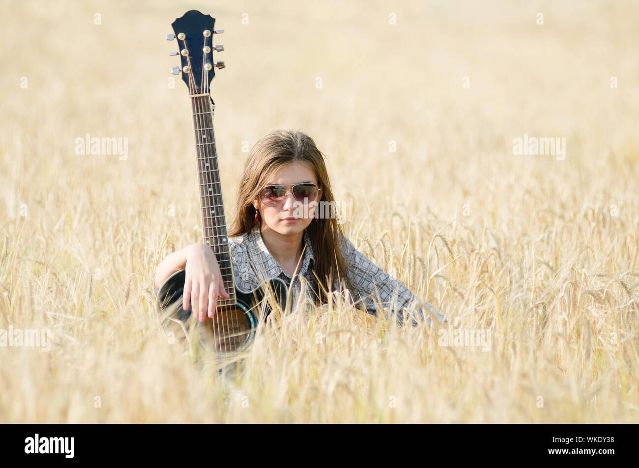 Rocking girl on a nature with guitar Stock Photo - Alamy