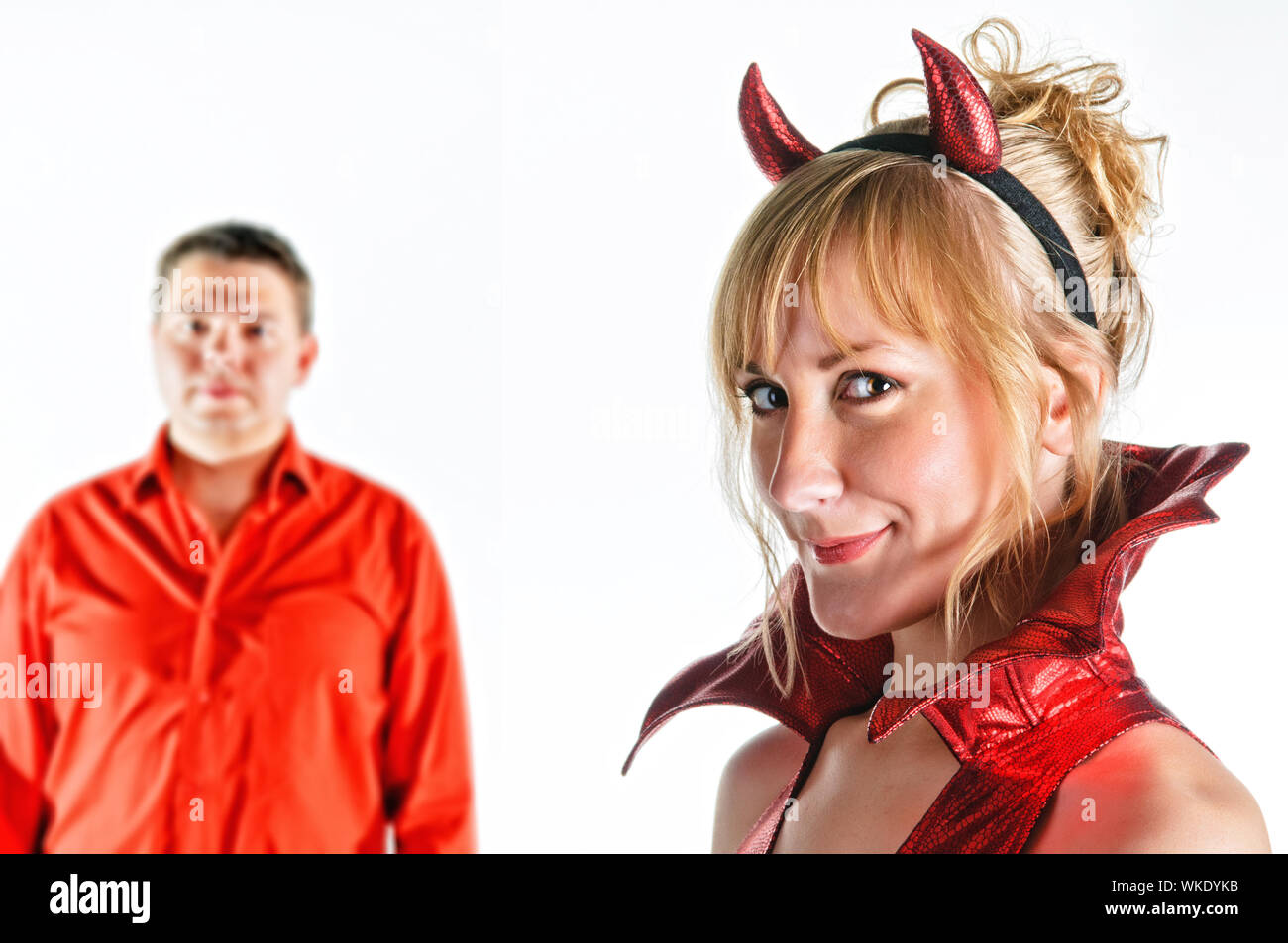 Red devil couple on white background Stock Photo - Alamy