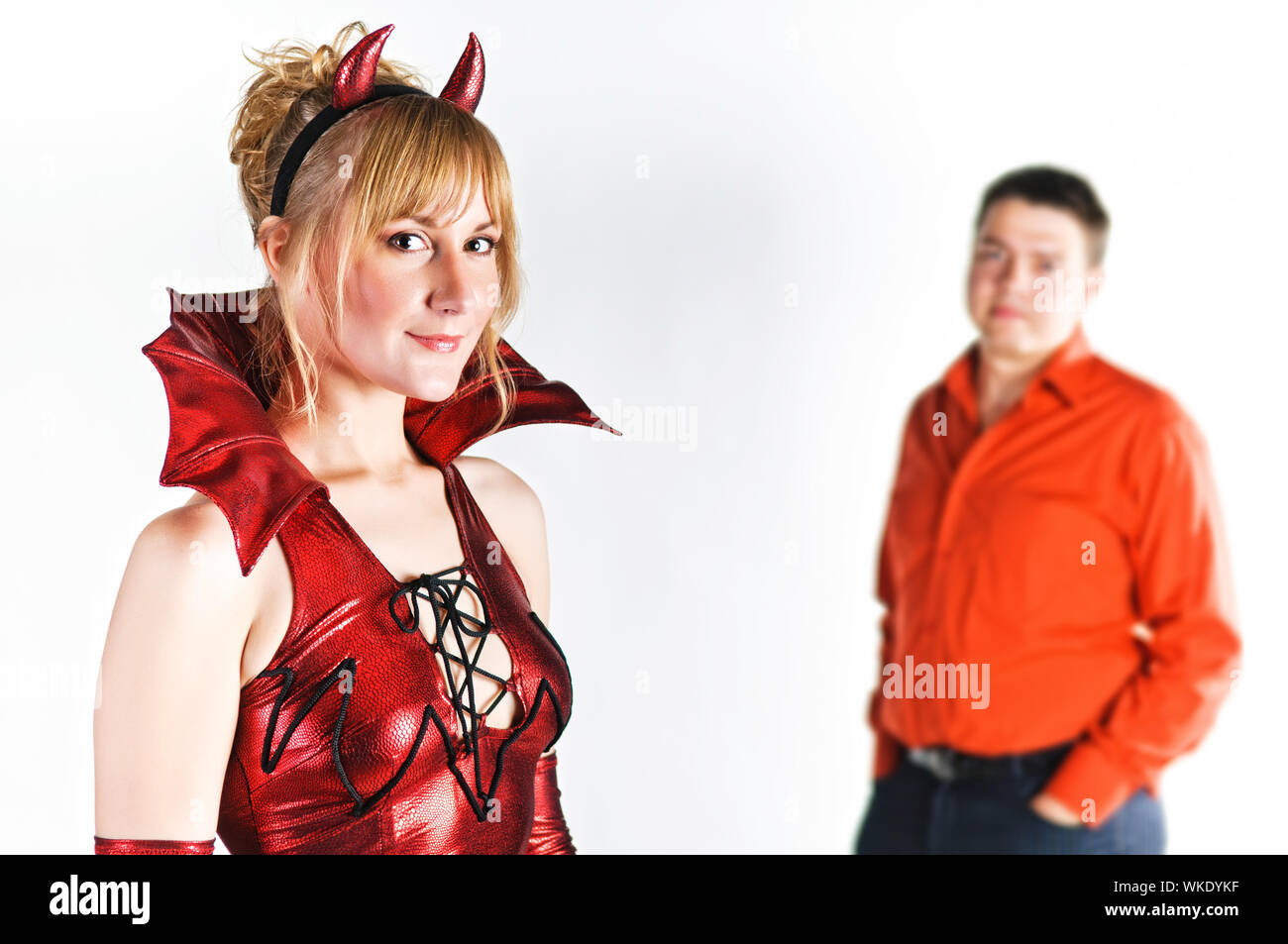 Red devil couple on white background Stock Photo - Alamy