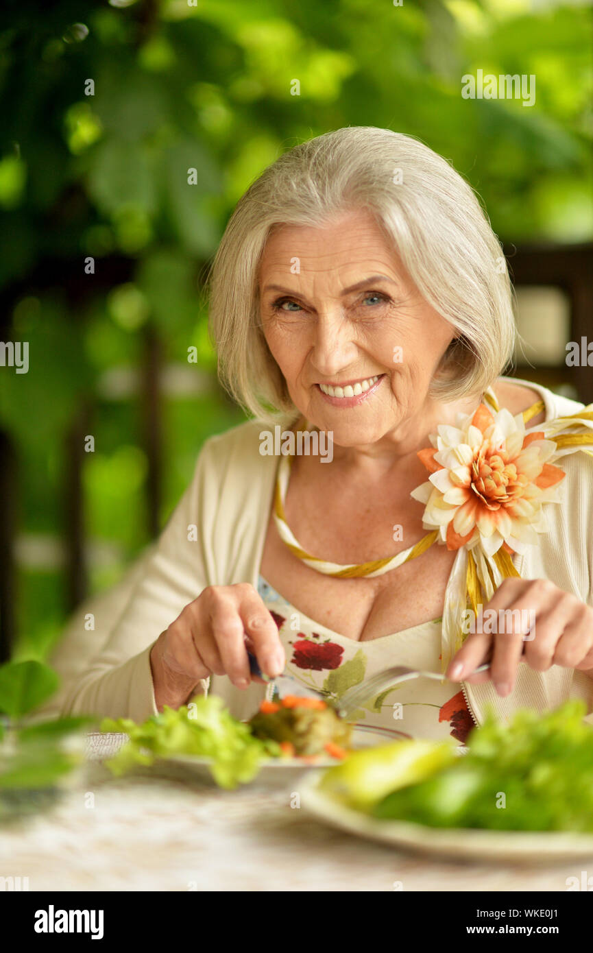 Portrait of a beautiful senior woman eating healthy breakfast Stock ...