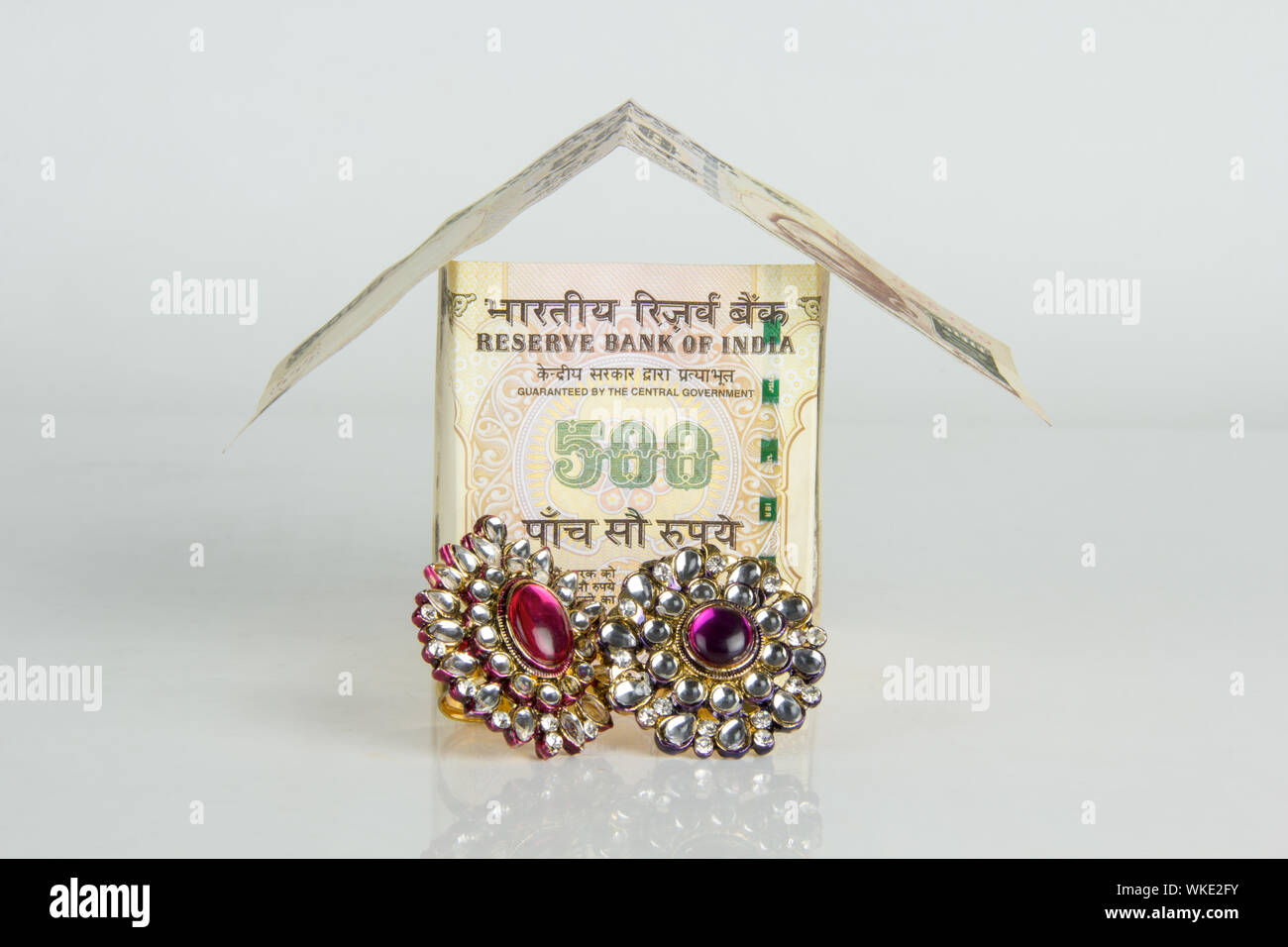 Model home made of five hundred rupee notes with rings Stock Photo - Alamy