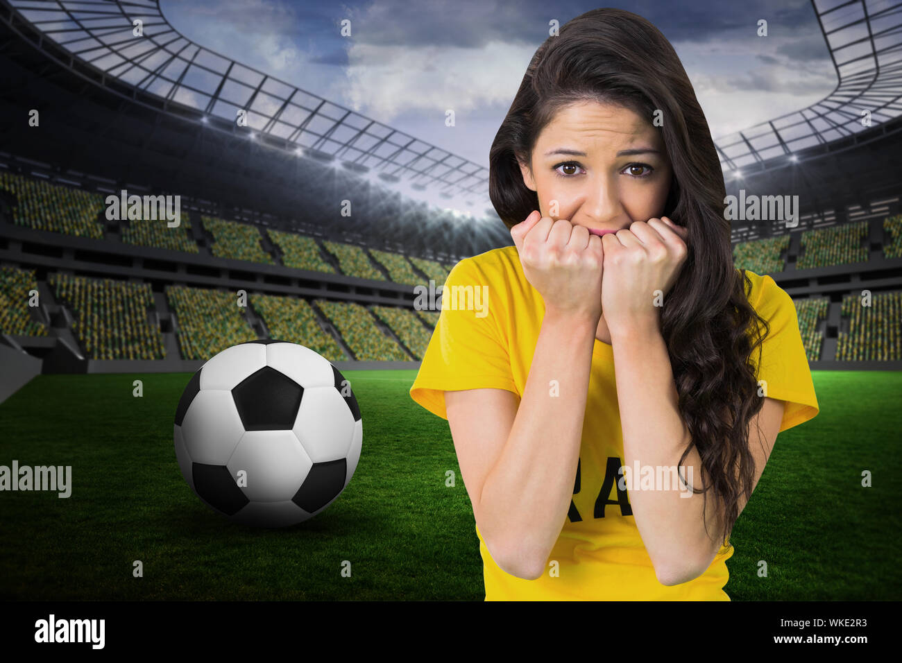 Nervous football fan in brasil tshirt against large football stadium ...