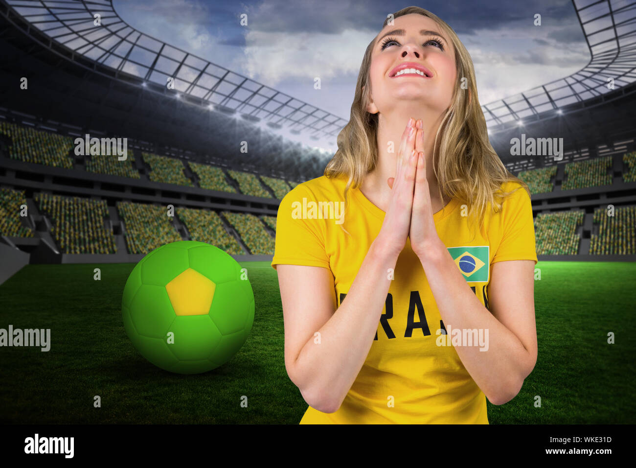Nervous football fan in brasil tshirt against large football stadium ...