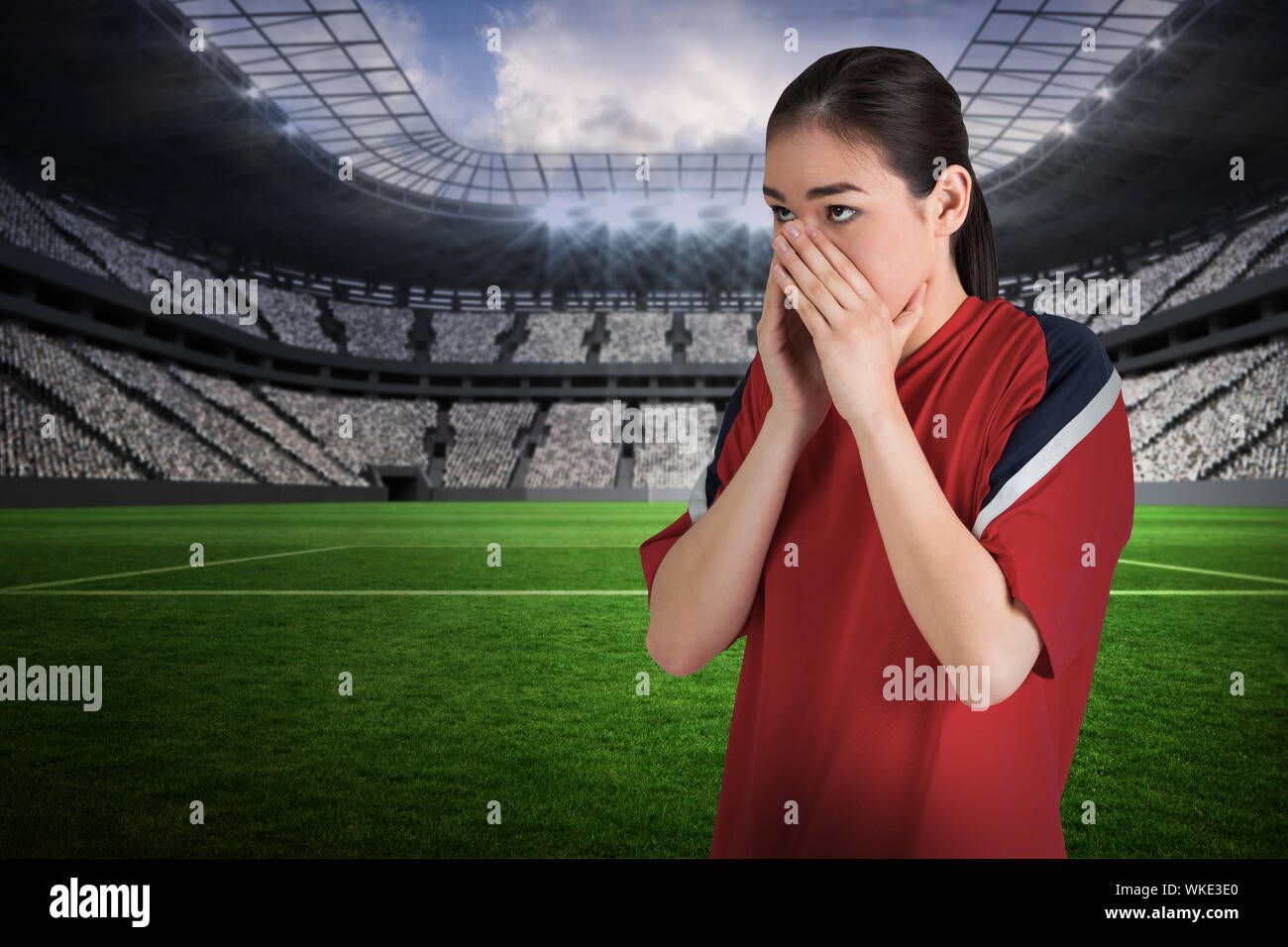Nervous football fan looking ahead in a vast football stadium with fans ...