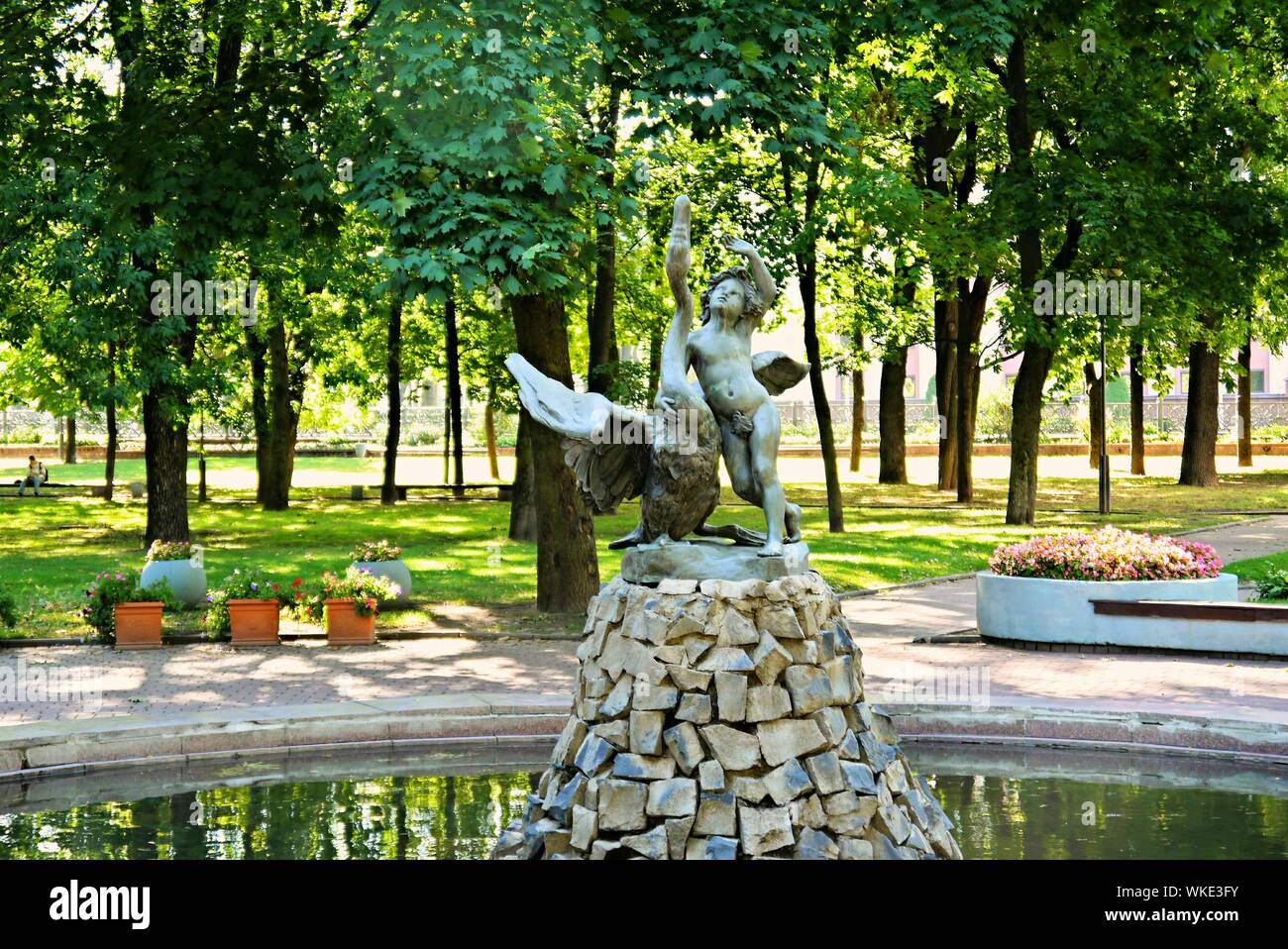Angel Statue In Pond Against Trees At Park Stock Photo - Alamy